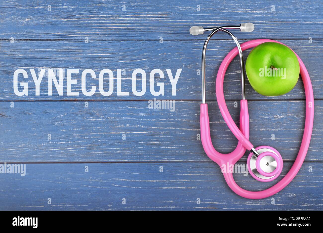 Gynecology concept. Stethoscope with apple on wooden table Stock Photo ...