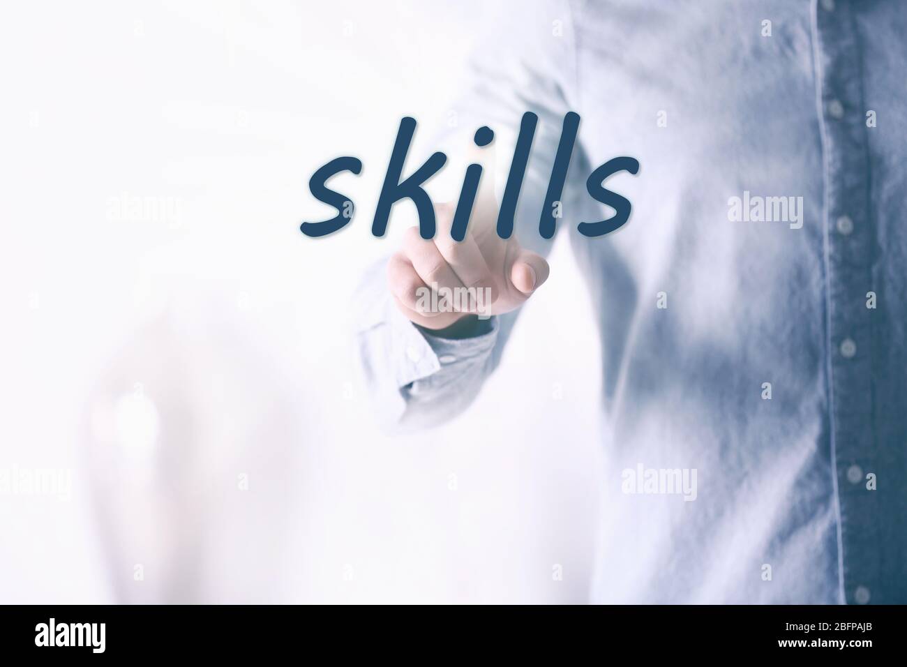 Skills. Young man push button on virtual screen Stock Photo - Alamy