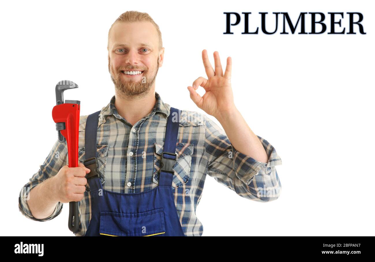 Plumbing concept. Portrait of handsome plumber with pipe wrench ...