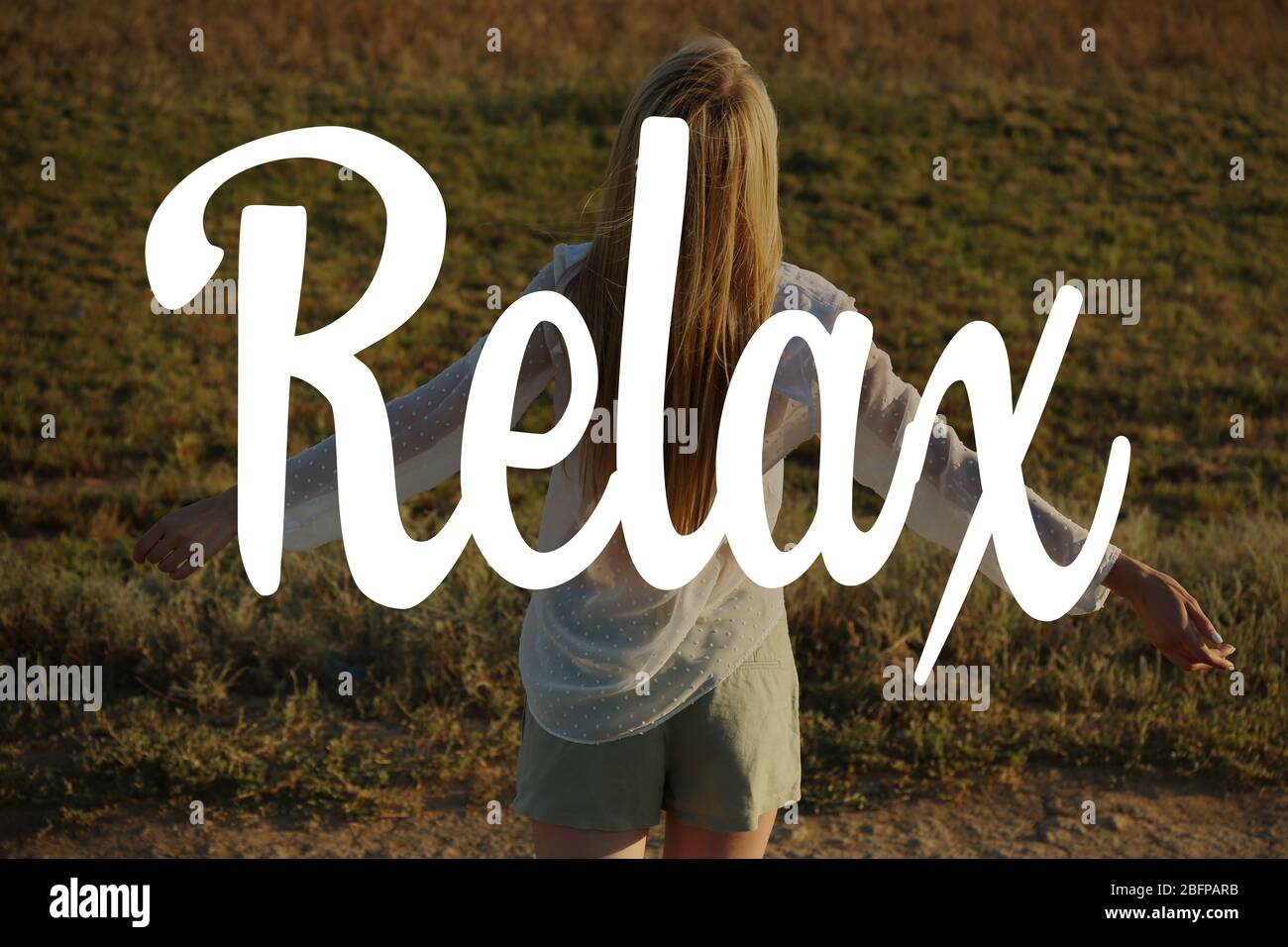 Word RELAX and young woman enjoying freedom Stock Photo - Alamy