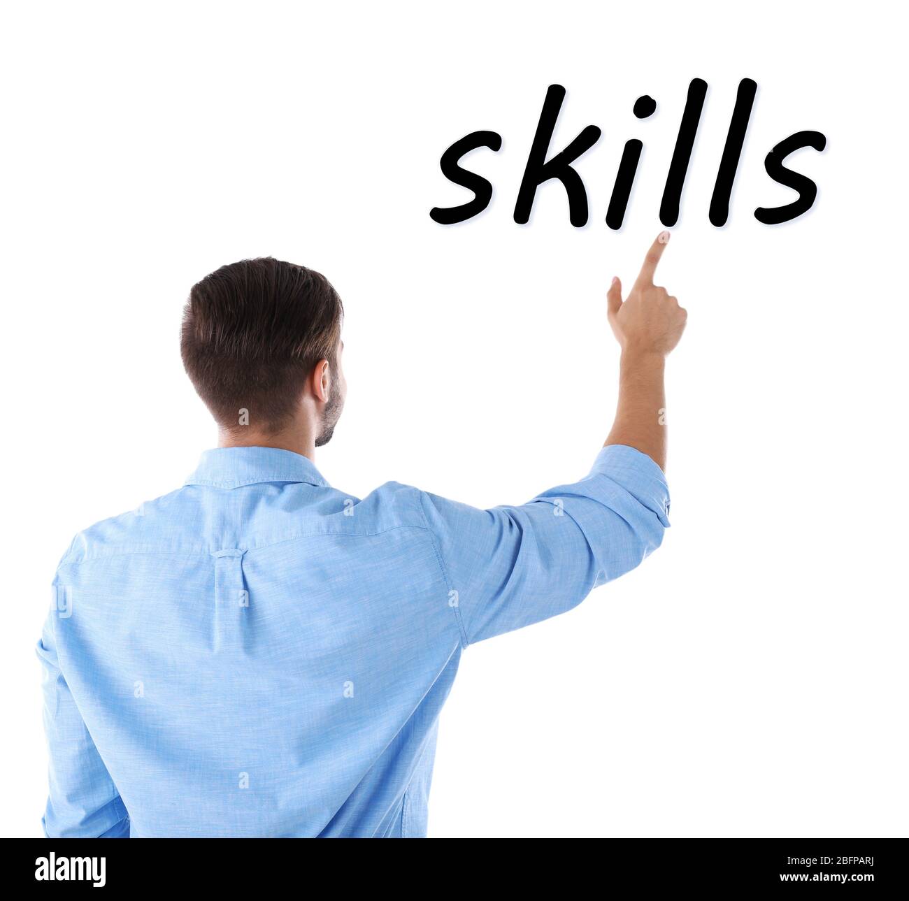 Skills. Back view of Caucasian young man in a blue shirt pointing ...