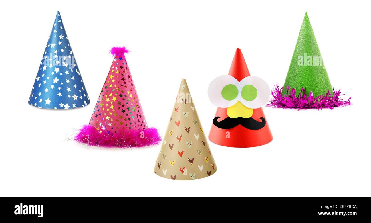 Colorful party caps on white background Stock Photo - Alamy
