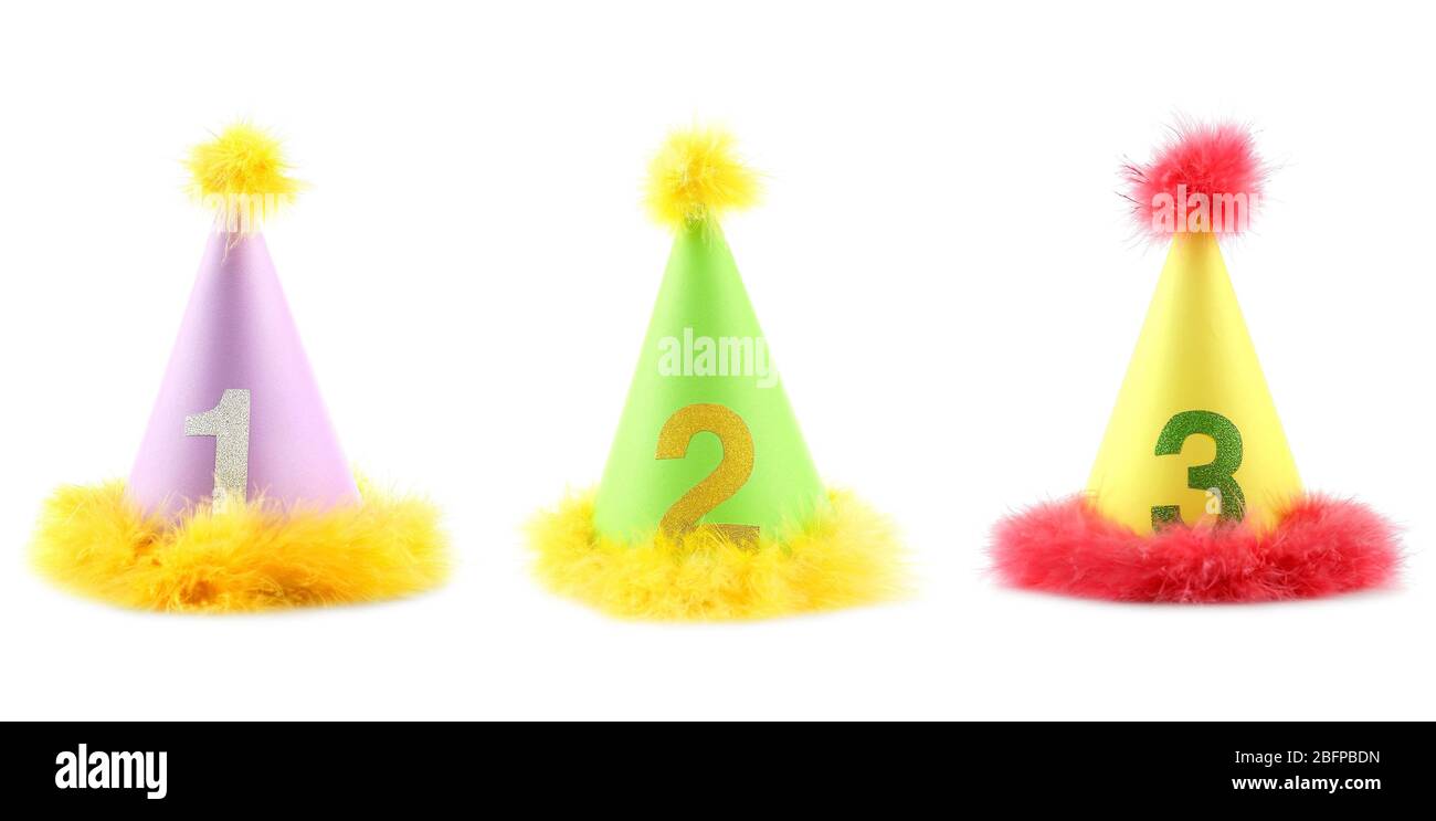 Colorful party caps on white background Stock Photo - Alamy