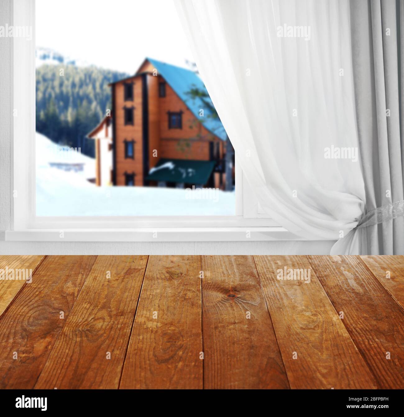 Wooden table on blurred winter window background Stock Photo - Alamy