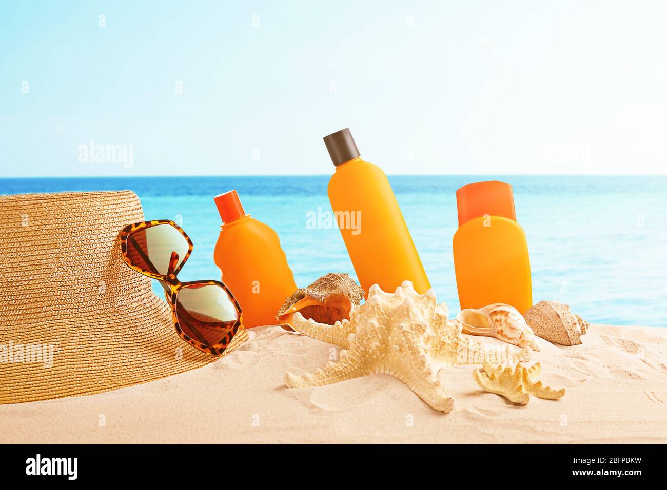 Accessories for tanning on beach on sea and sky background Stock Photo ...