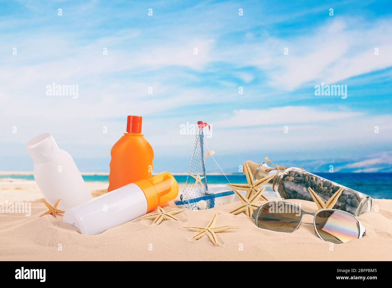 Accessories for tanning on beach on sea and sky background Stock Photo ...