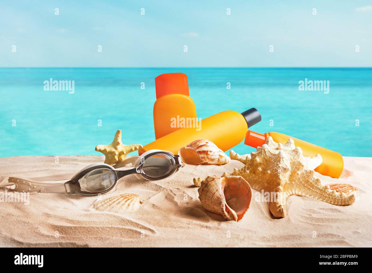 Accessories for tanning on beach on sea and sky background Stock Photo ...