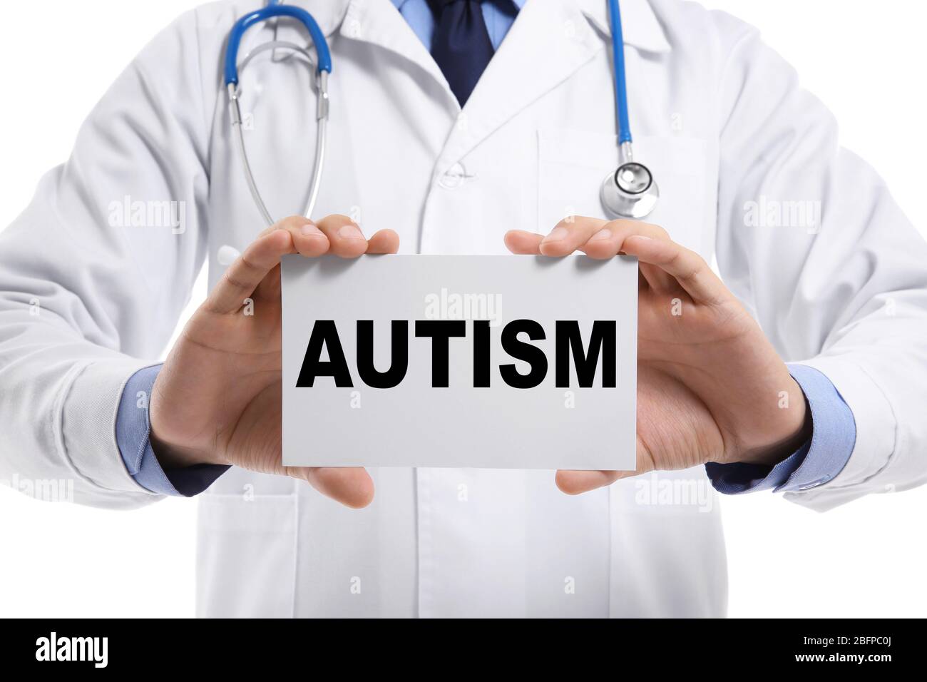 Children autism concept. Male doctor holding paper on white background ...