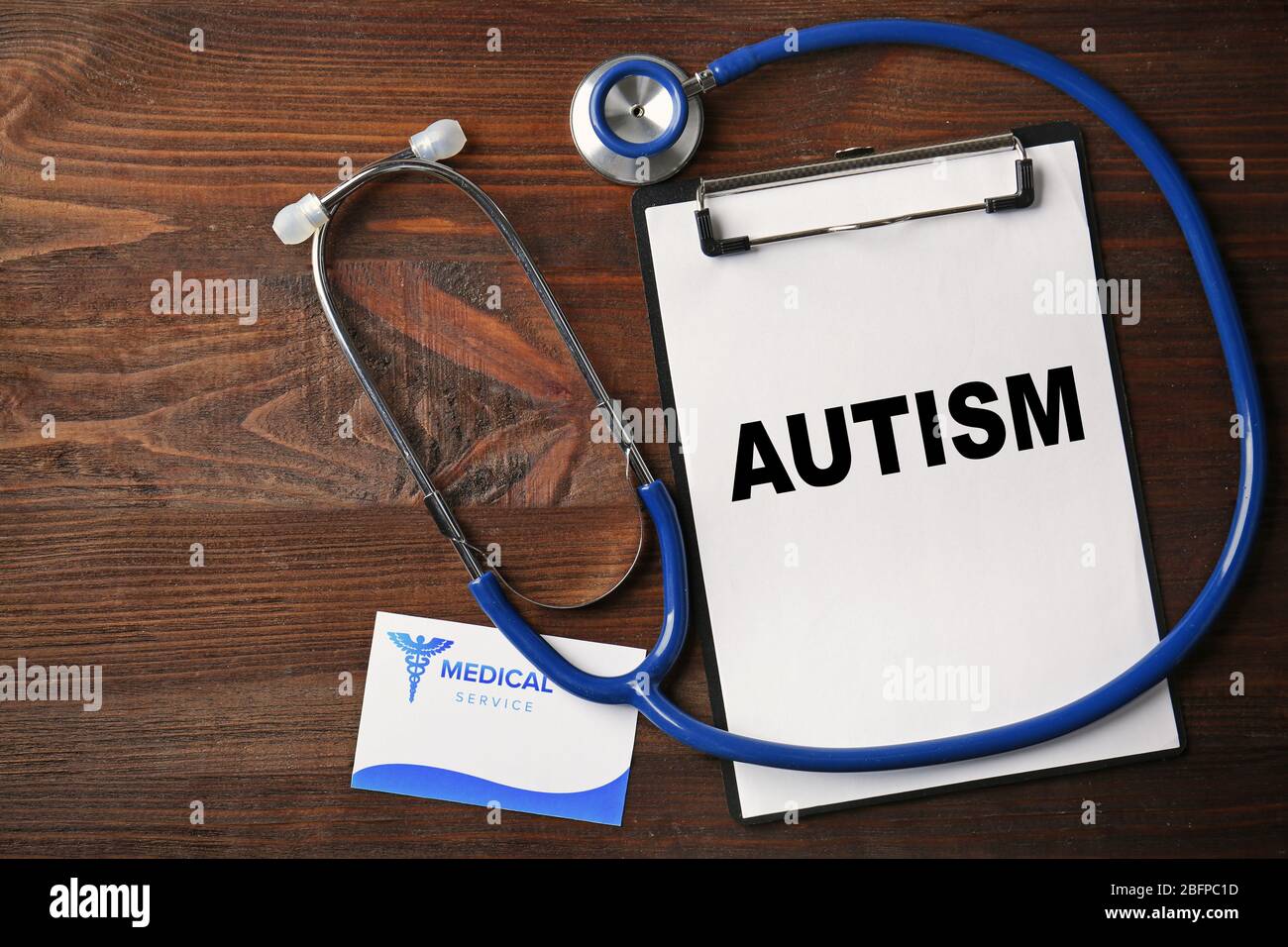 Children autism concept. Clipboard and stethoscope on wooden background ...