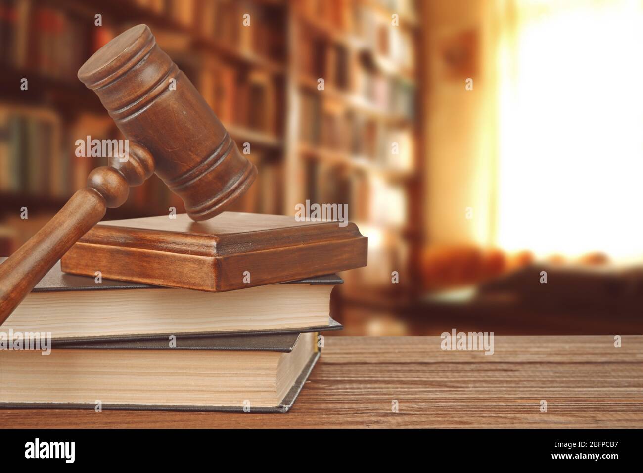 Gavel with sound block on bookshelf in library background Stock Photo ...