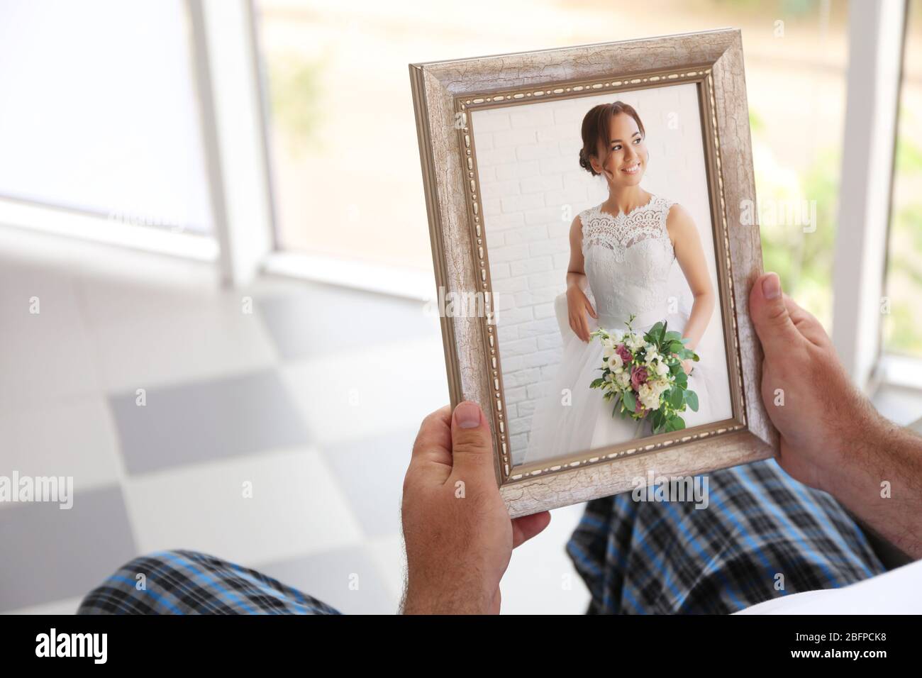 Male hands holding photo frame with picture of young woman. Happy ...