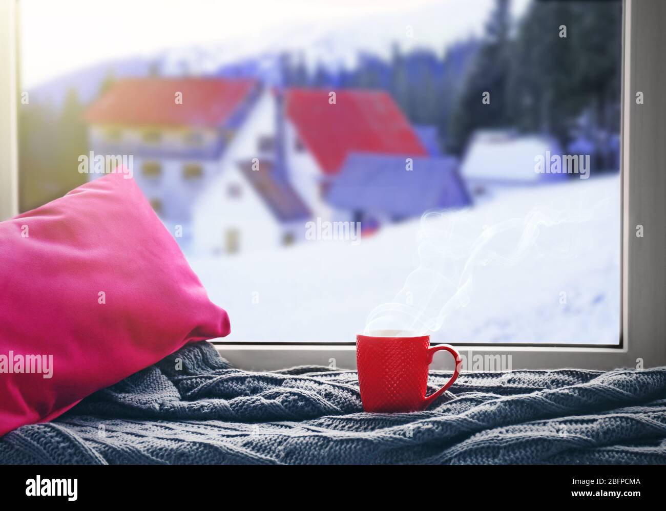 Cup of hot drink on the windowsill in winter landscape background Stock ...