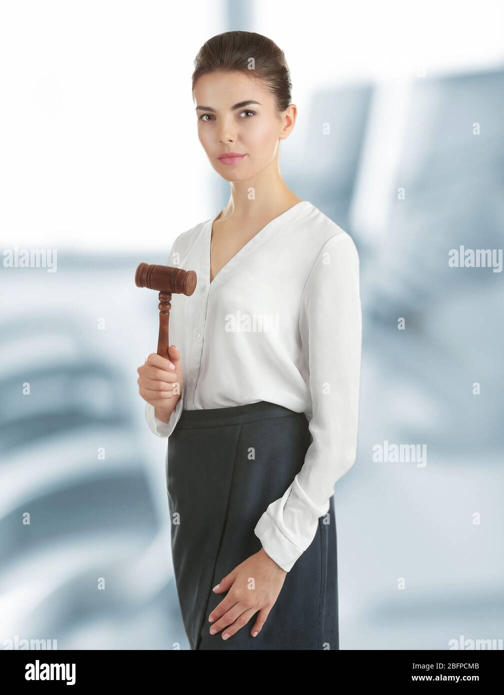 Beautiful woman with judge gavel on blurred office background. Justice ...