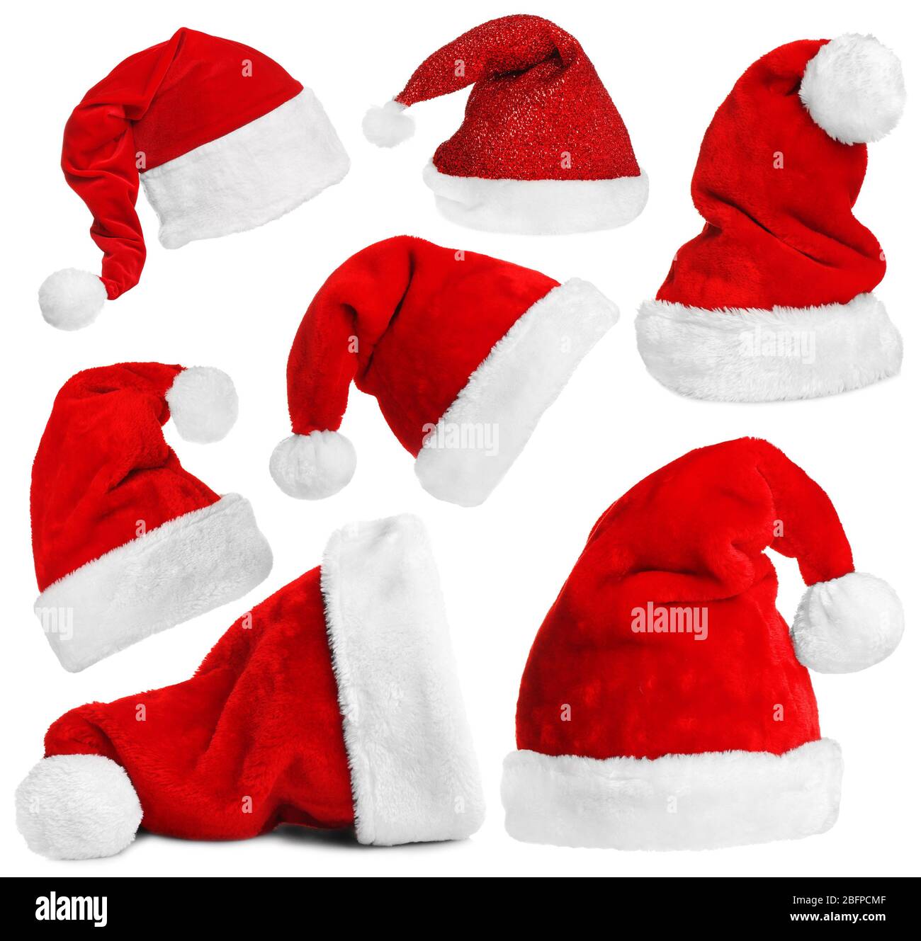 Santa Claus hats isolated on white Stock Photo - Alamy