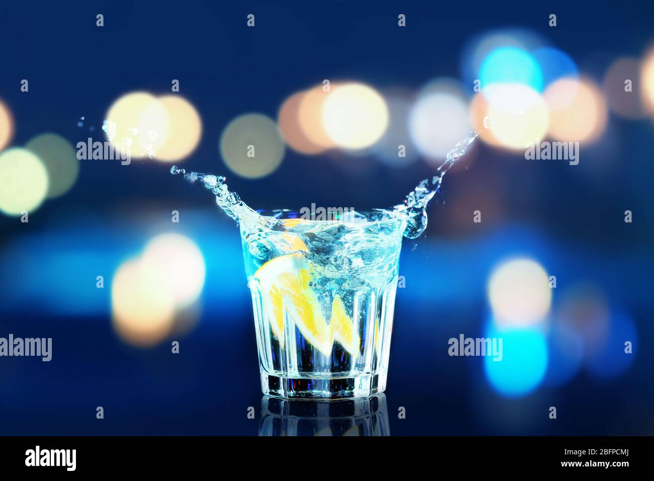 Colorful cocktail with splash on lights background Stock Photo - Alamy