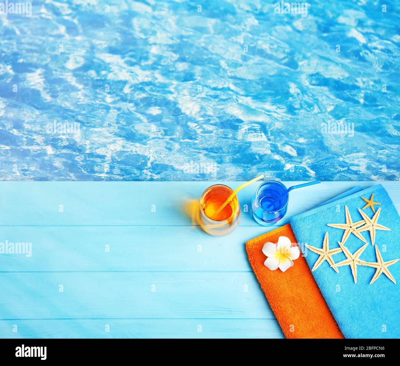 Summer beach set on swimming pool water background Stock Photo - Alamy