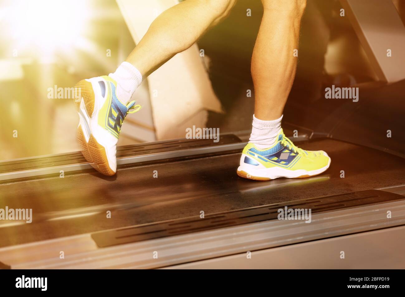 Man running on treadmill in gym Stock Photo - Alamy