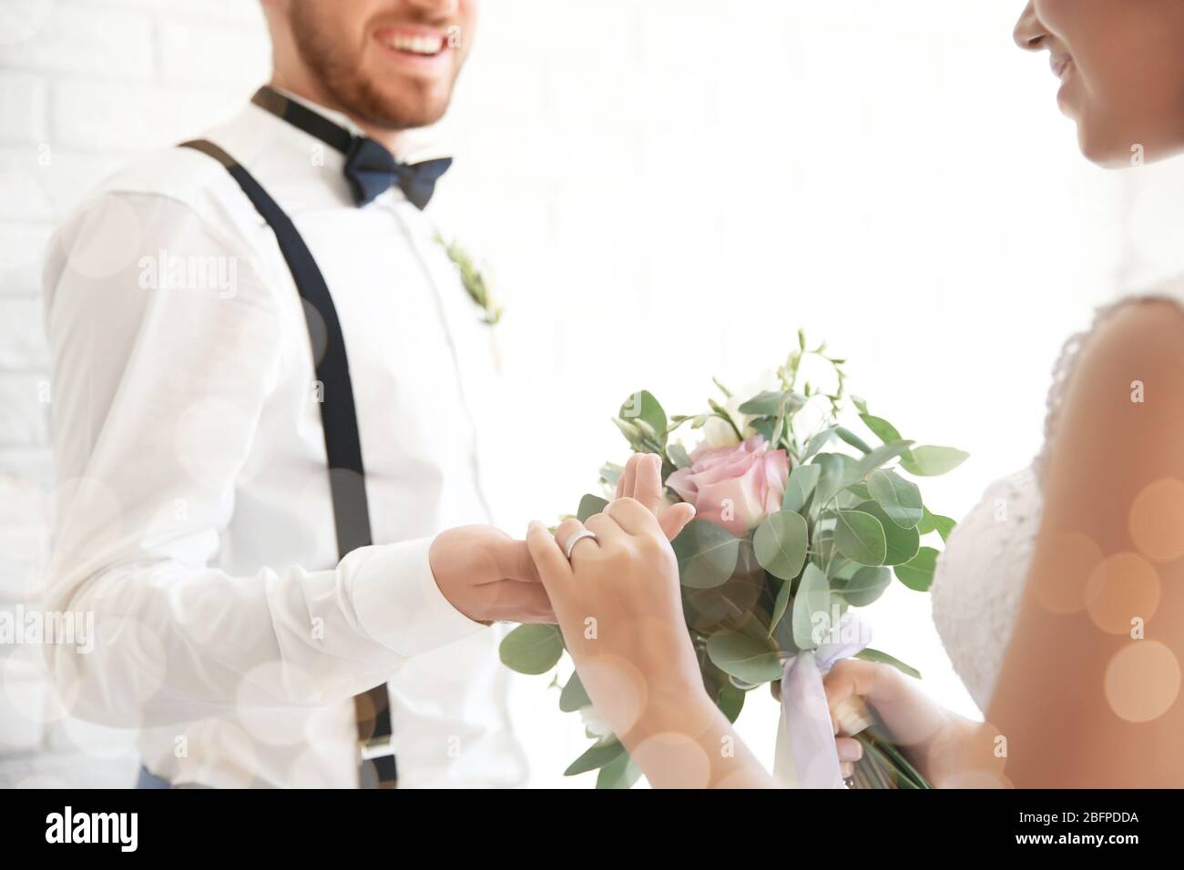 Groom and bride holding hands together Stock Photo - Alamy