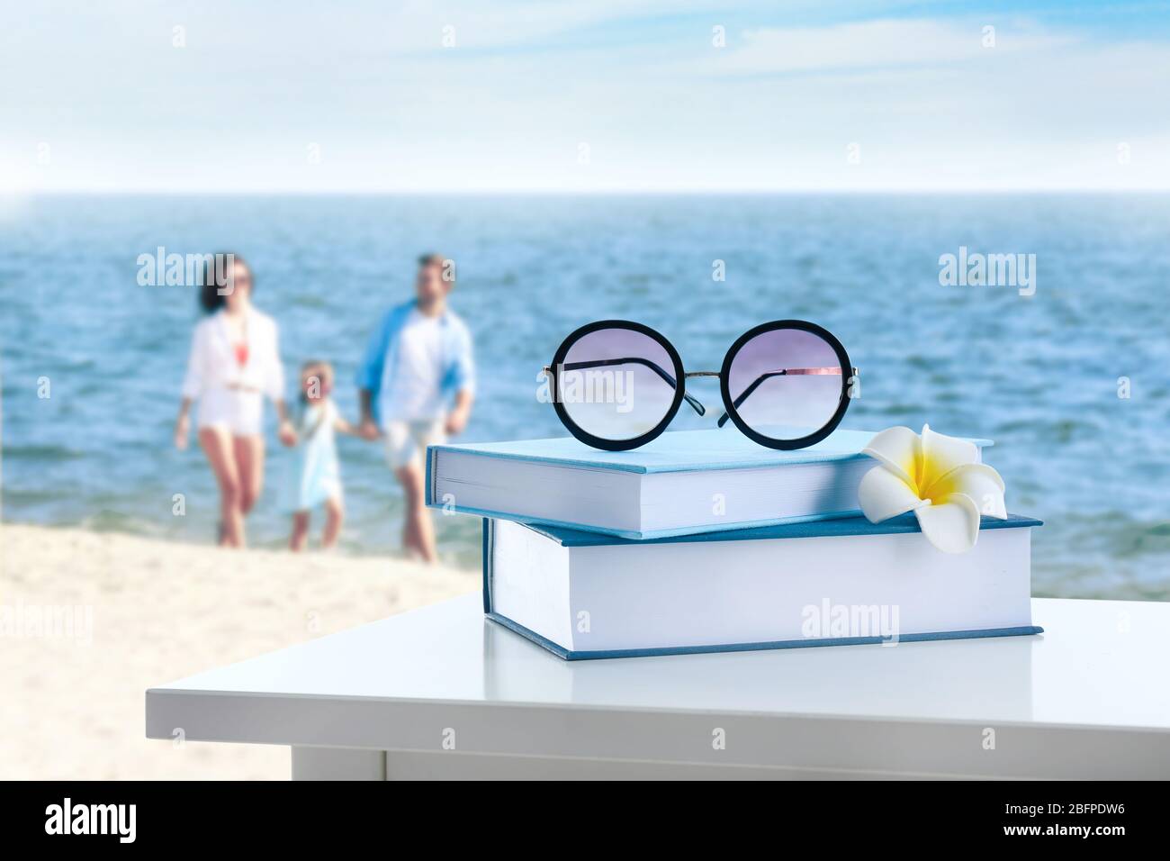 Reading during summer vacation. Books and sunglasses on landscape ...