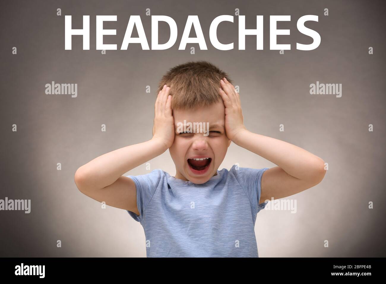 Little boy suffering from headaches on color background Stock Photo - Alamy