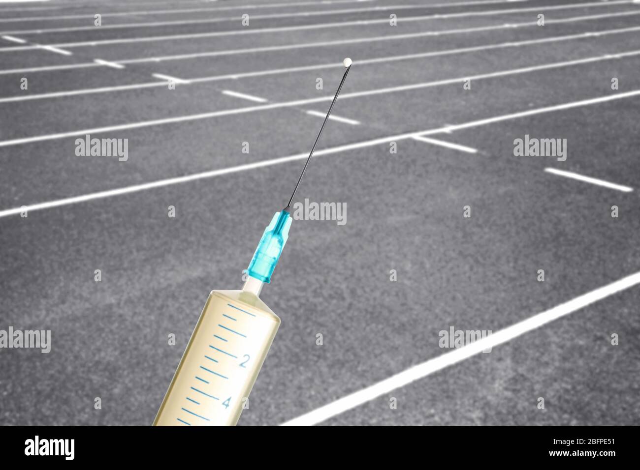 Syringe with substance and running track on background. Sport and ...