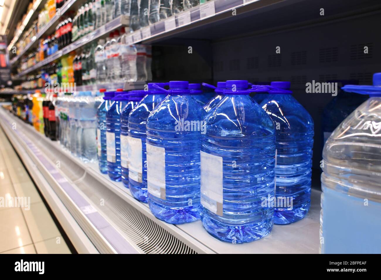 Bottles of water on shelf at supermarket Stock Photo - Alamy
