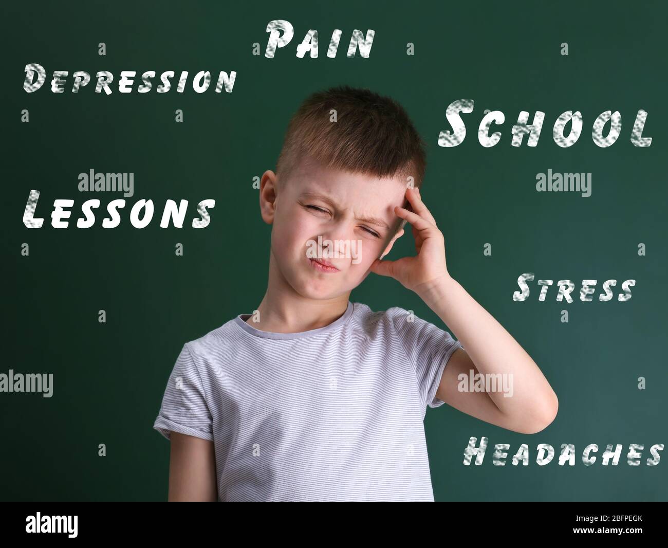Little boy suffering from headaches on blackboard background Stock ...