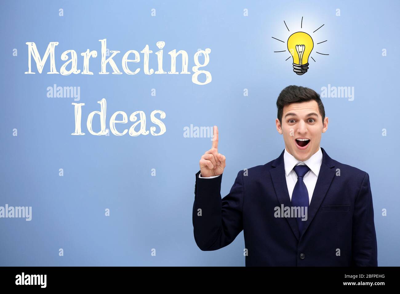 Marketing ideas concept. Young man and drawing of light bulb on color ...