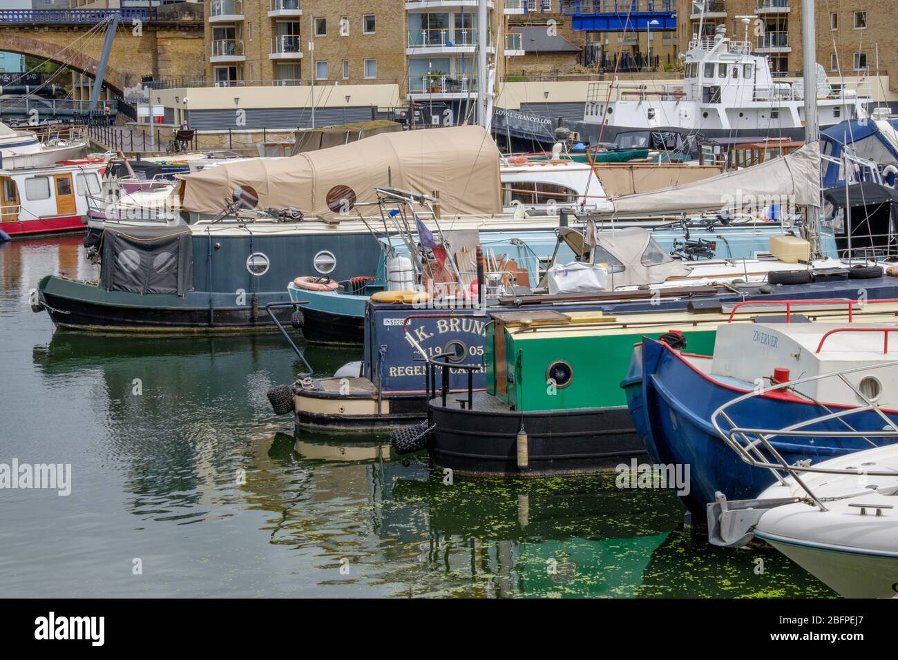Various types of boats moored at Limehouse Marina with residential ...