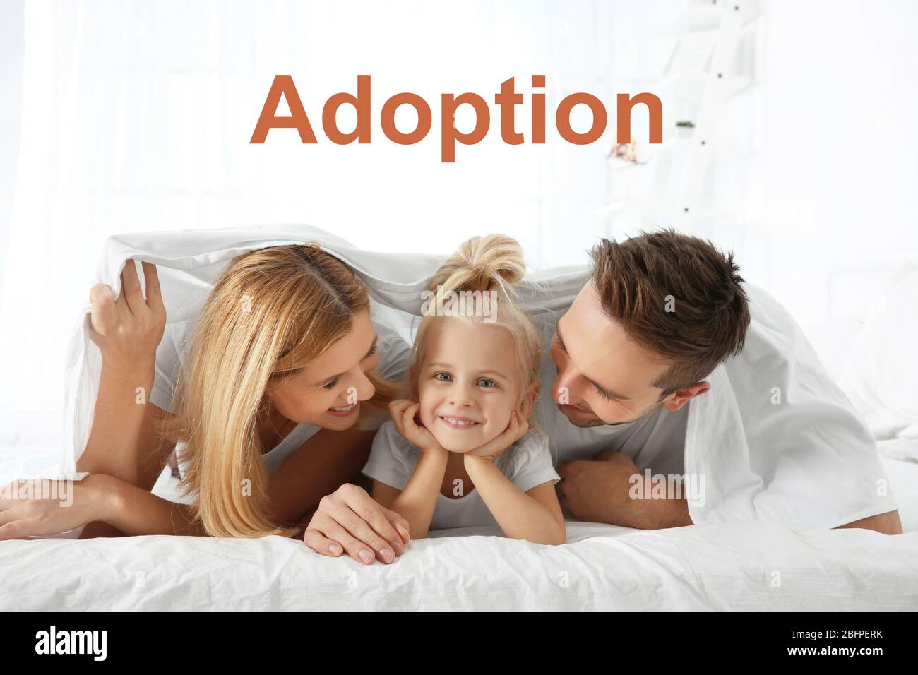 Adoption concept. Happy family in bed at home Stock Photo - Alamy