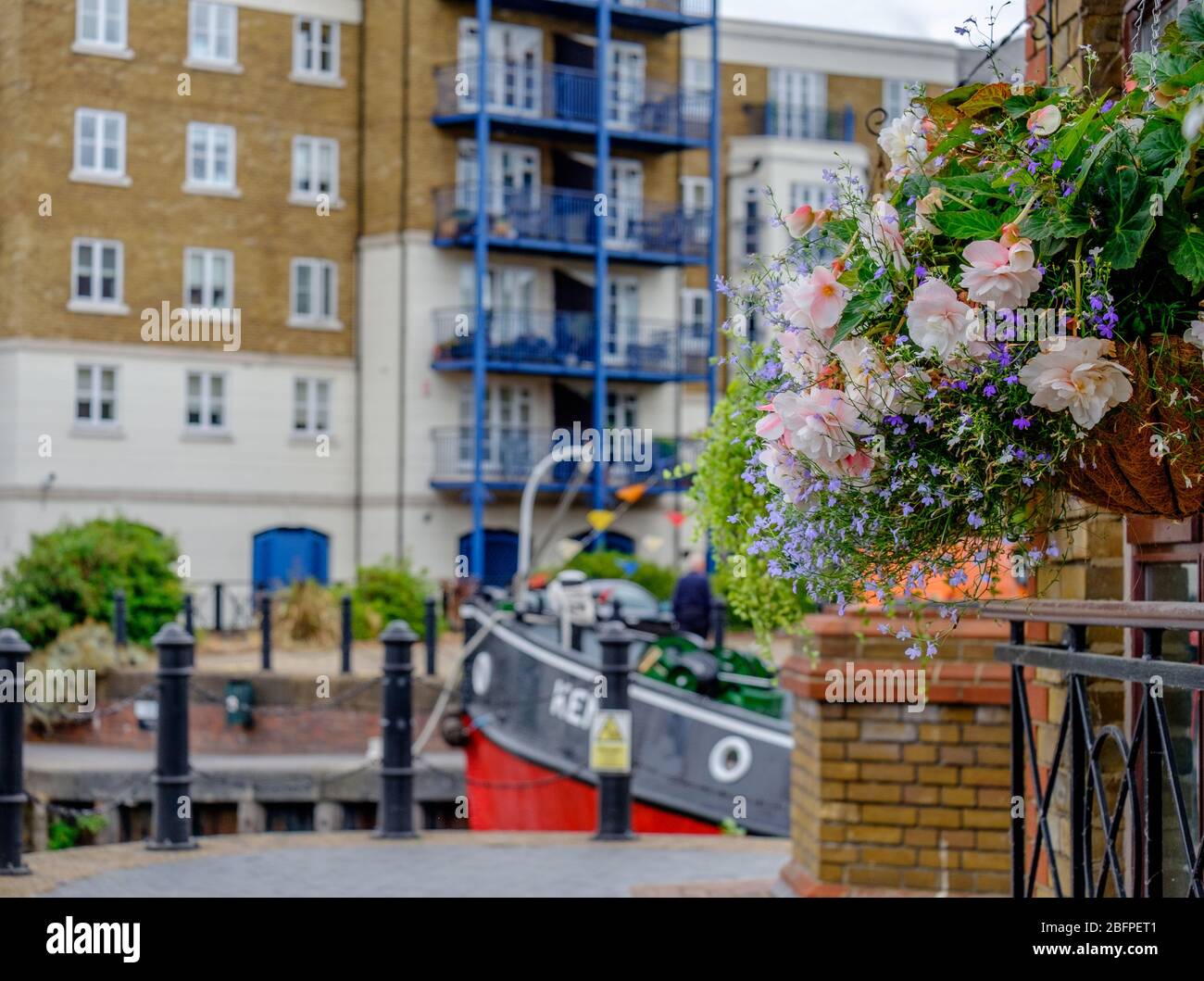 Flower arrangement on side of building with boats and residential ...