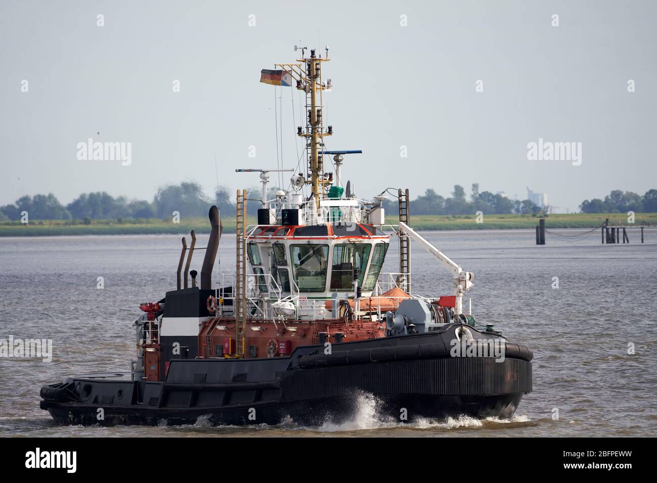 a tugboat drives at a river Stock Photo - Alamy