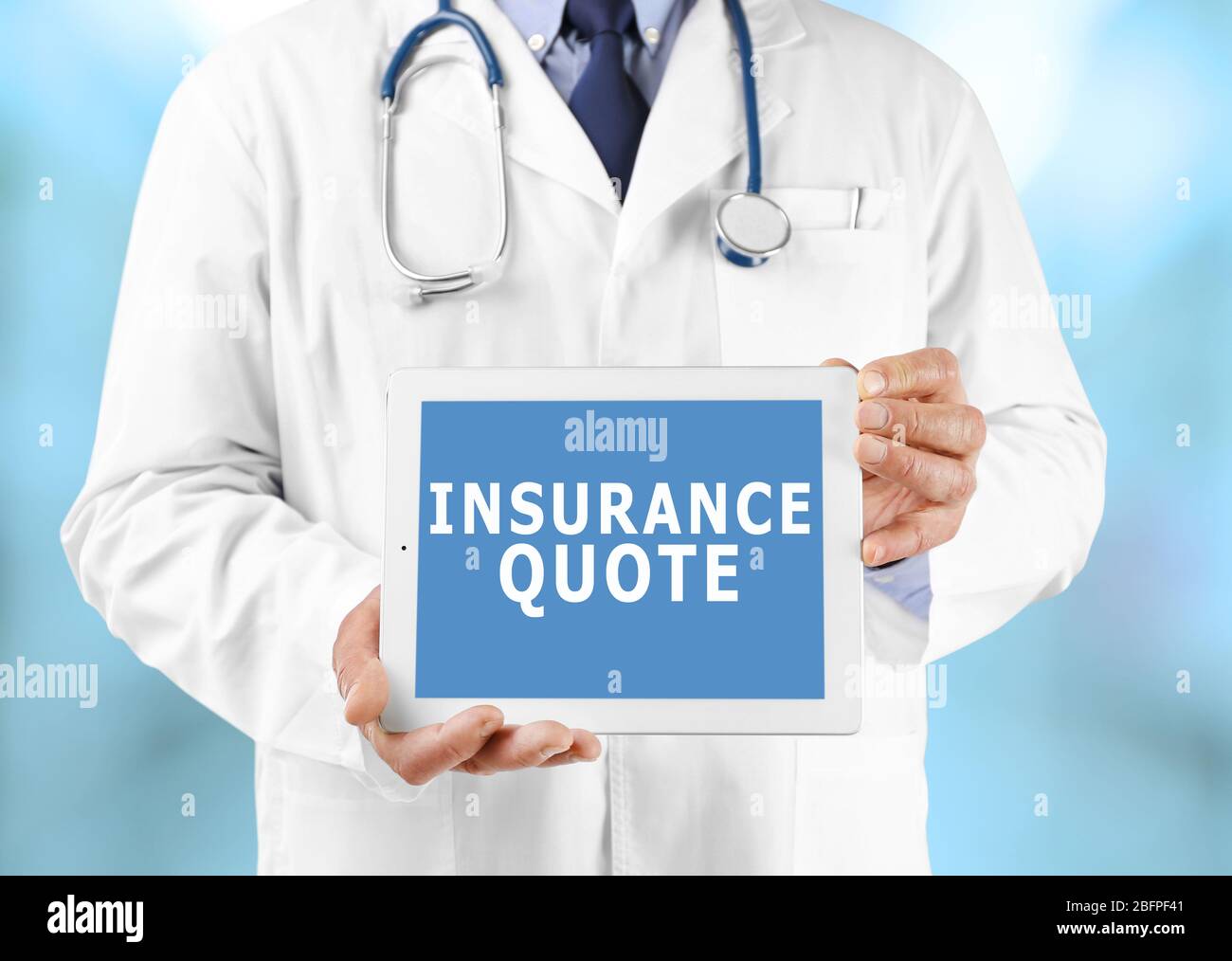 Insurance quote concept. Doctor holding tablet with text on screen ...