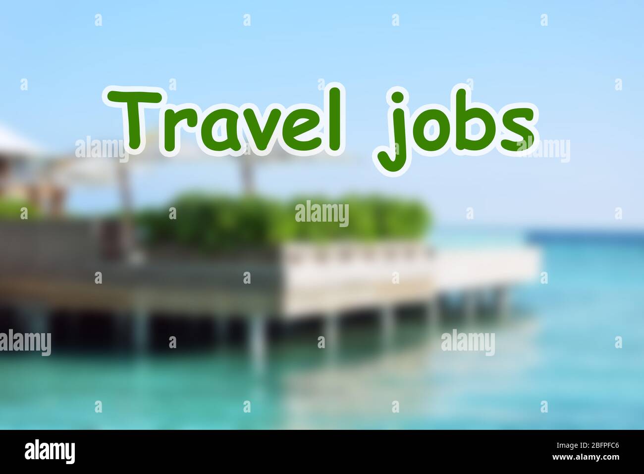 Concept of tourism and work. Text TRAVEL JOBS and blurred resort on ...