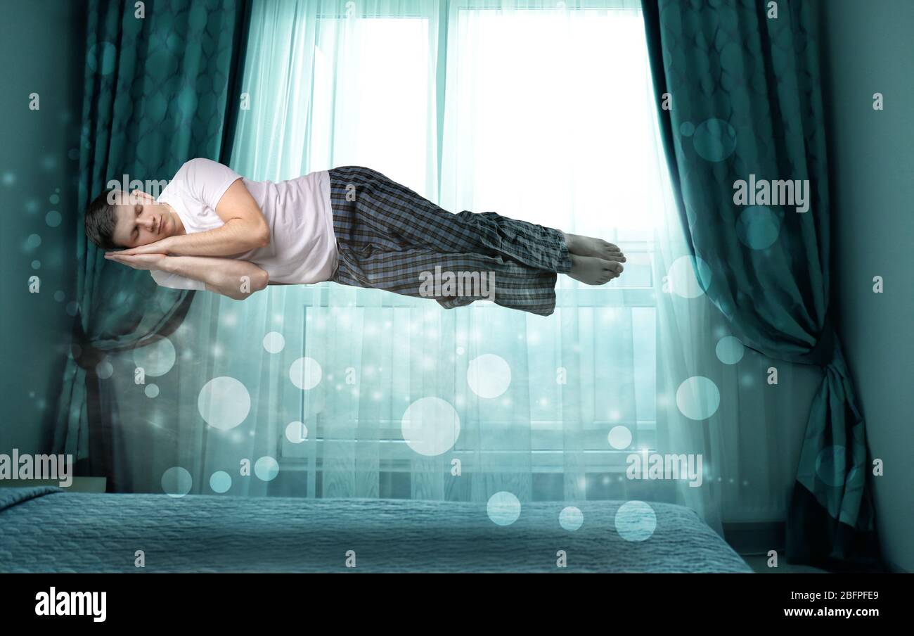 Sleep paralysis concept. Young man levitating over bed Stock Photo - Alamy