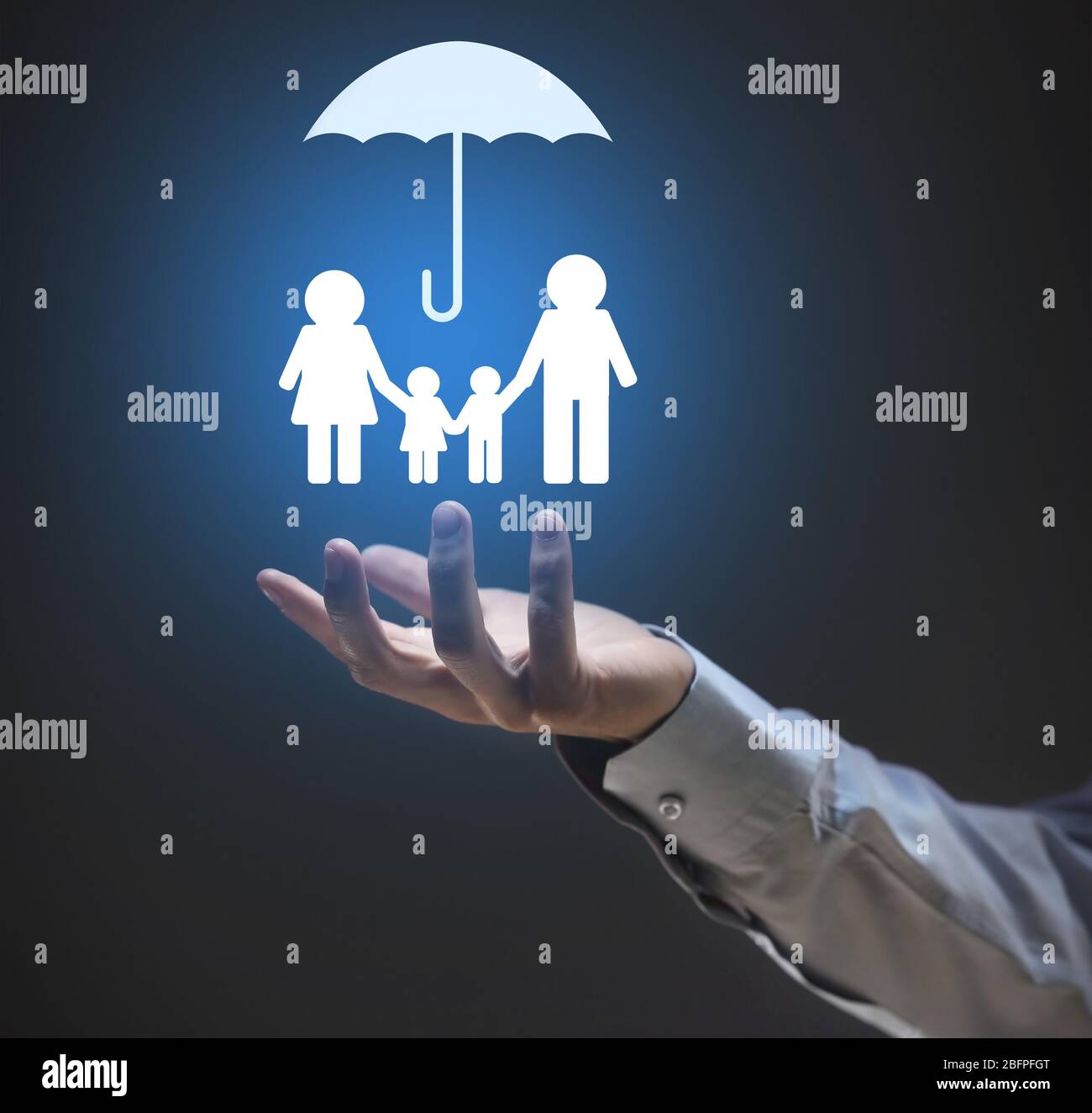 Insurance concept. Businessman holding symbol of family in hand ...