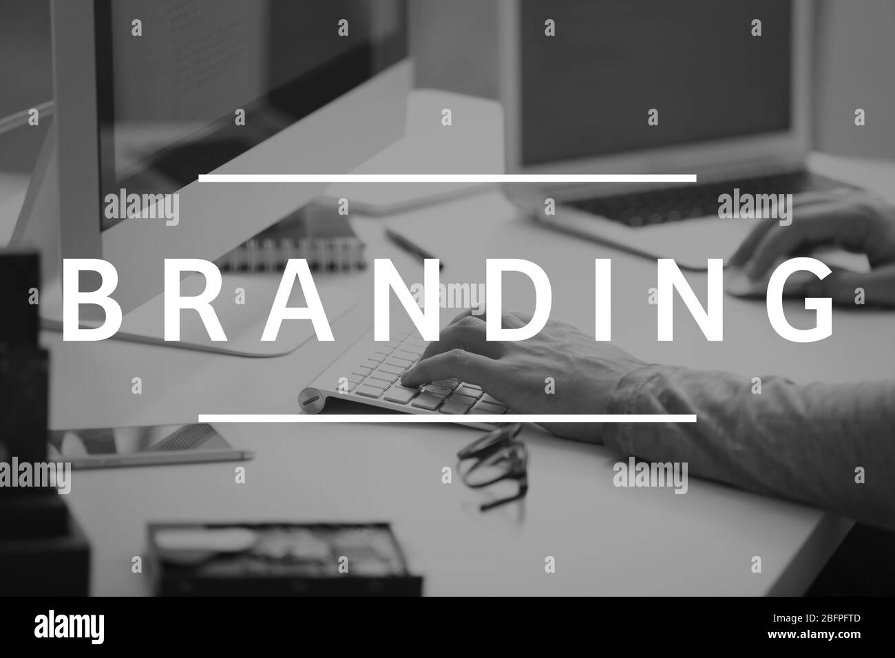 Brand marketing concept. Word BRANDING and man working with computer on ...
