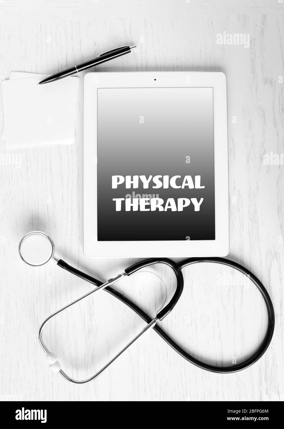 Rehabilitation concept. Tablet and stethoscope on wooden background ...