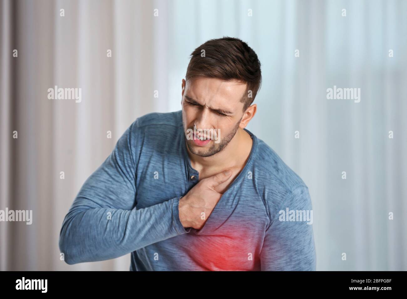 Heart attack concept. Man suffering from chest pain indoor Stock Photo ...