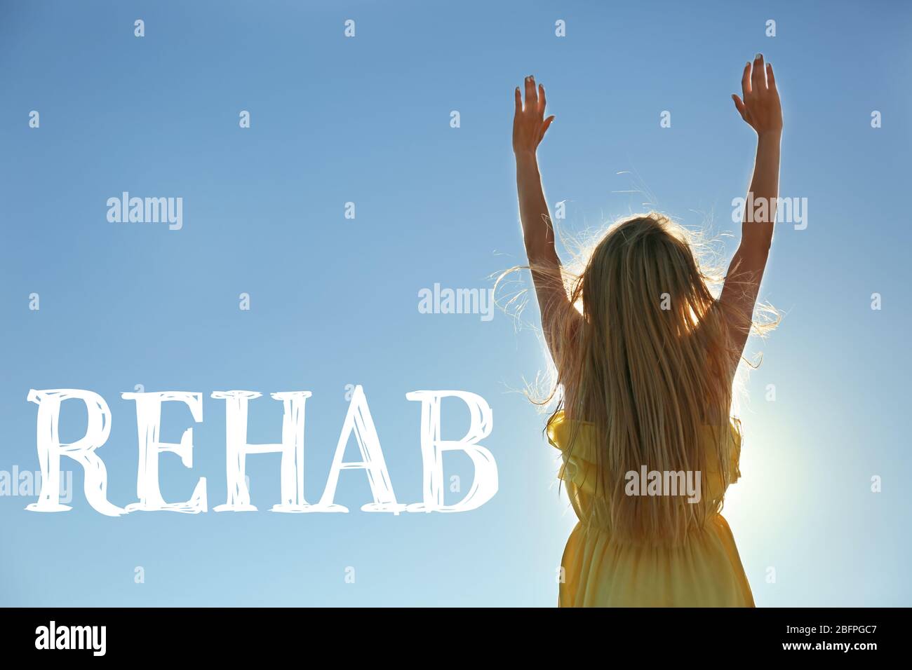 Recovery concept. Word REHAB and woman raising hands on sky background ...