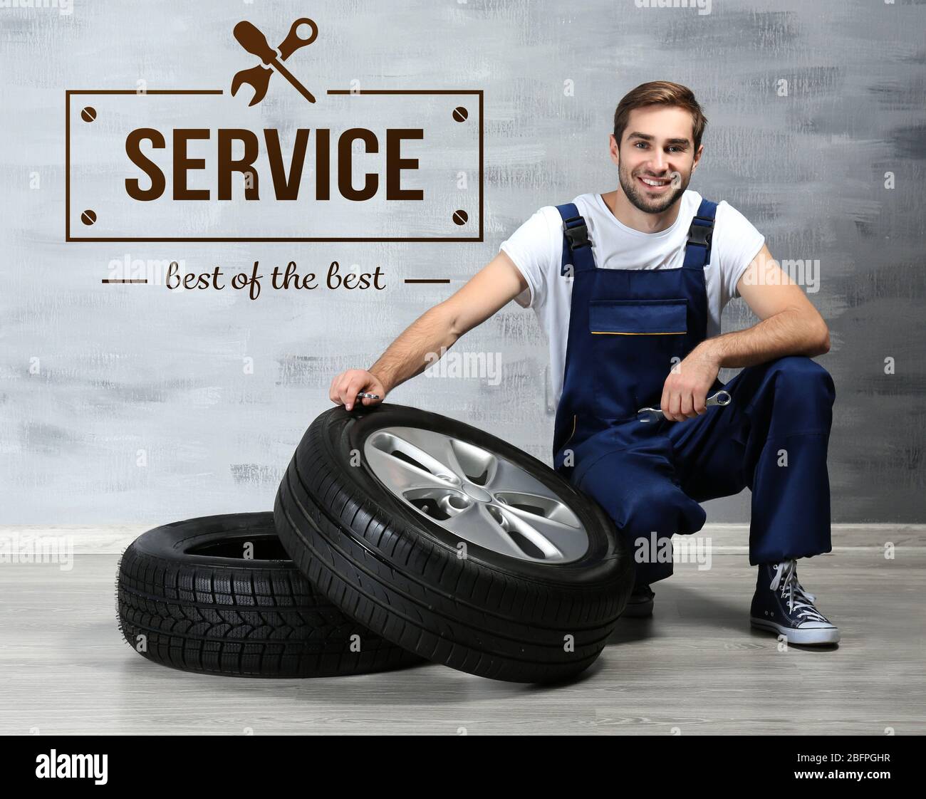 Concept of car service. Mechanic with tool and wheels on color wall ...