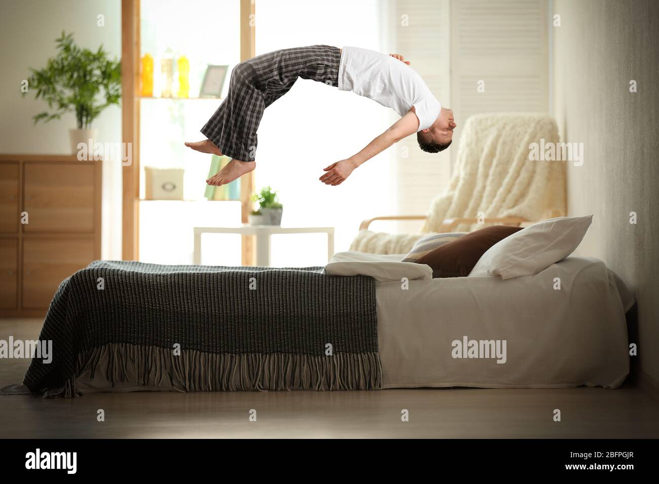 Sleep paralysis concept. Young man levitating over bed Stock Photo - Alamy