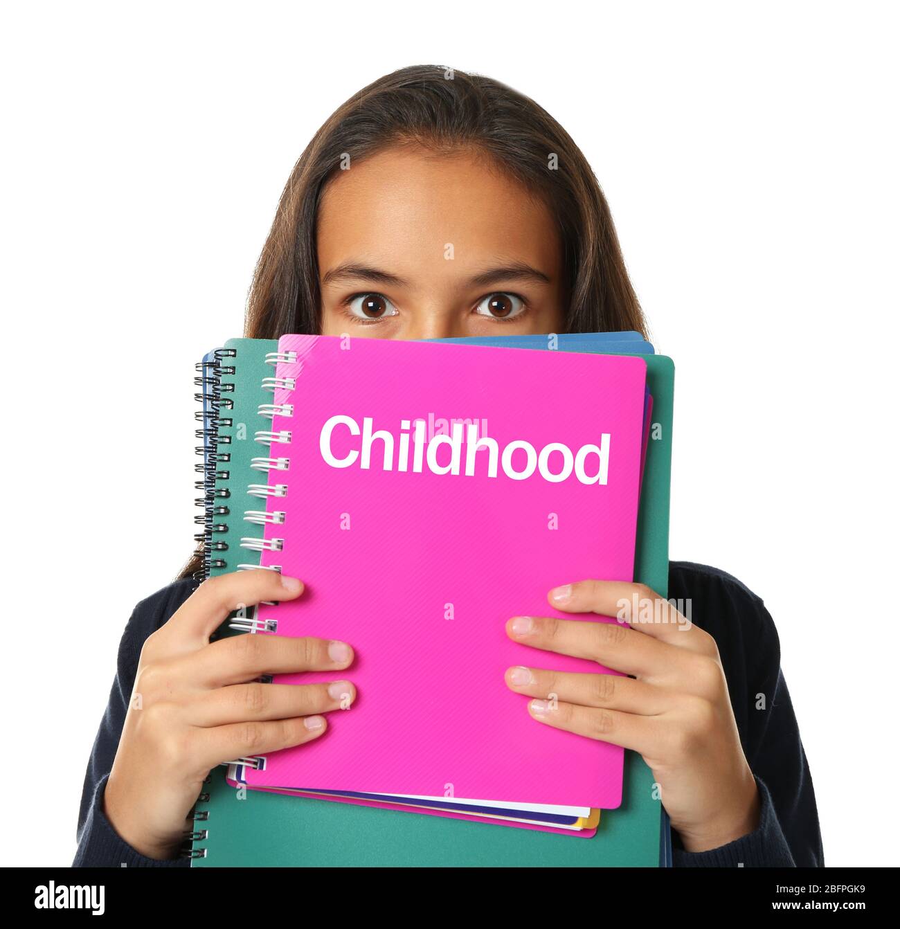 Cute girl holding notebooks on white background Stock Photo - Alamy