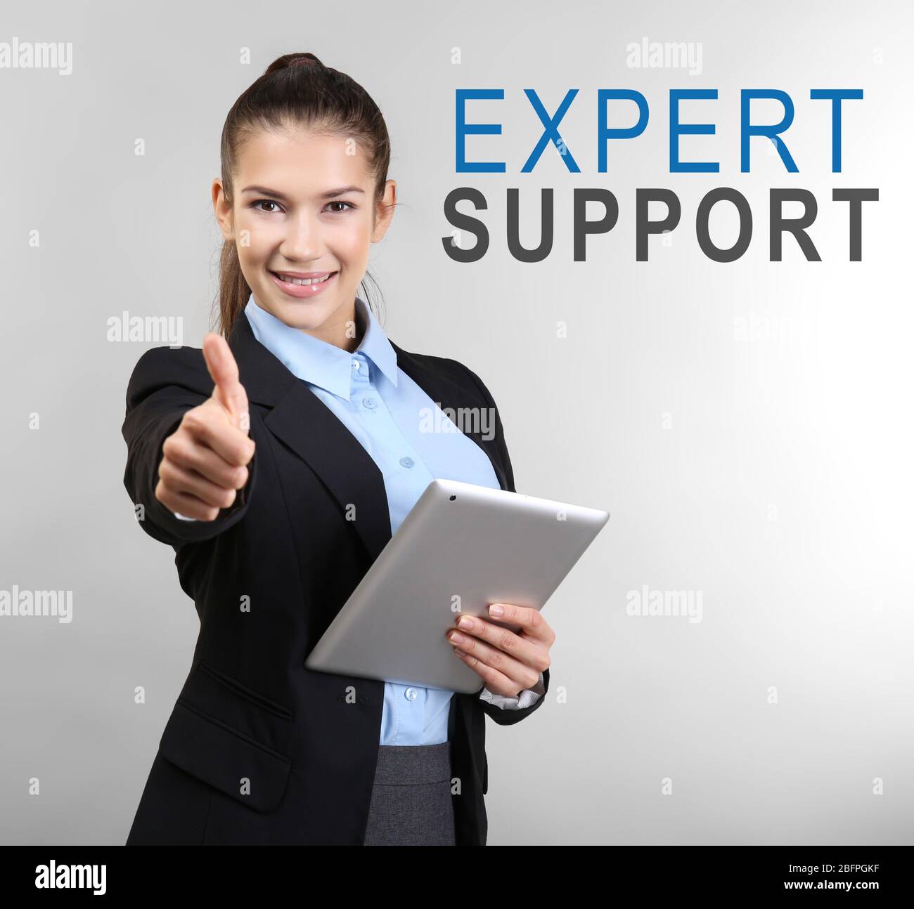 Expert support concept. Young woman with tablet on light background ...