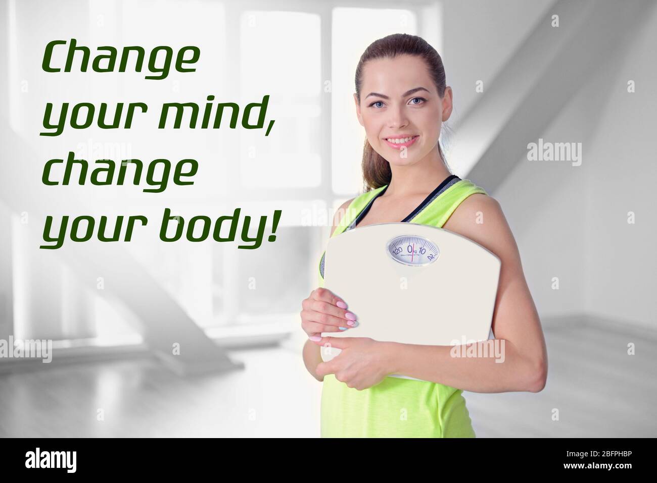 Weight loss motivation concept. Young woman holding scales at home ...