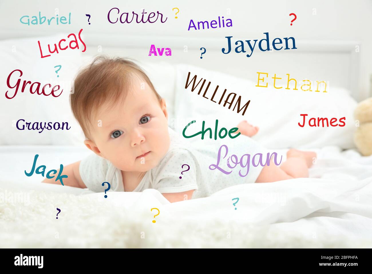 Baby names concept. Cute little child lying on bed at home Stock Photo ...