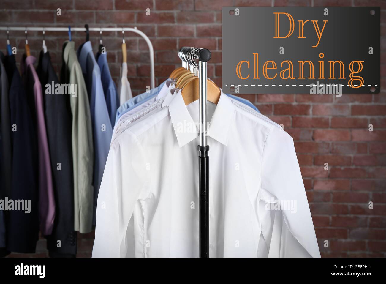 Concept of dry cleaning service. Hangers with clean clothes hanging on ...