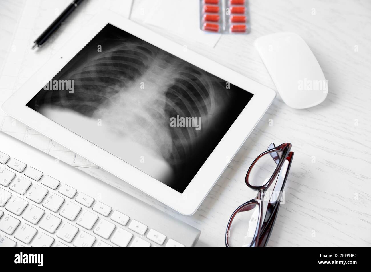 Asthma and health care concept. Tablet with glasses on wooden ...