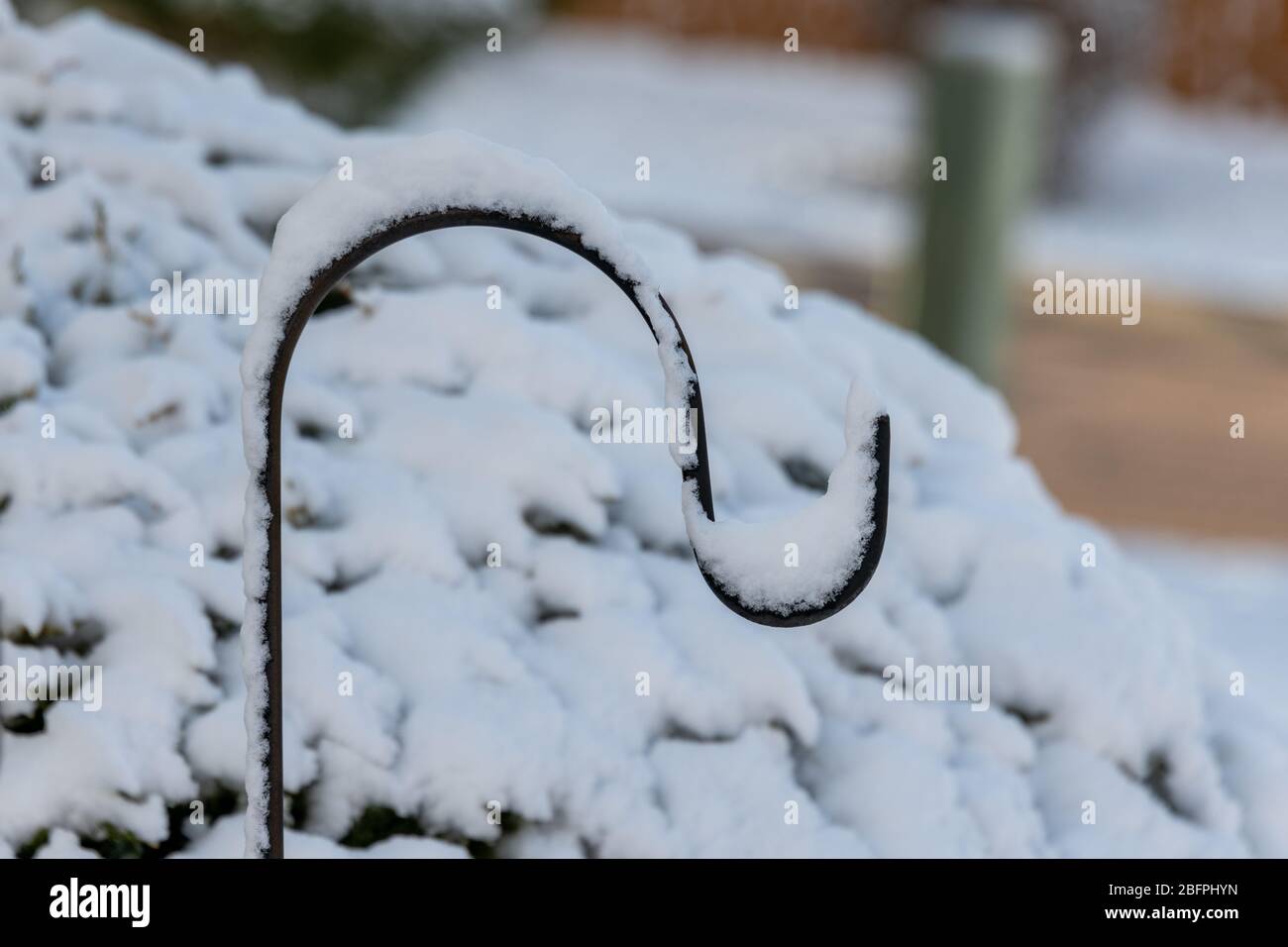 A pile of snow onto of a hook in a garden Stock Photo - Alamy