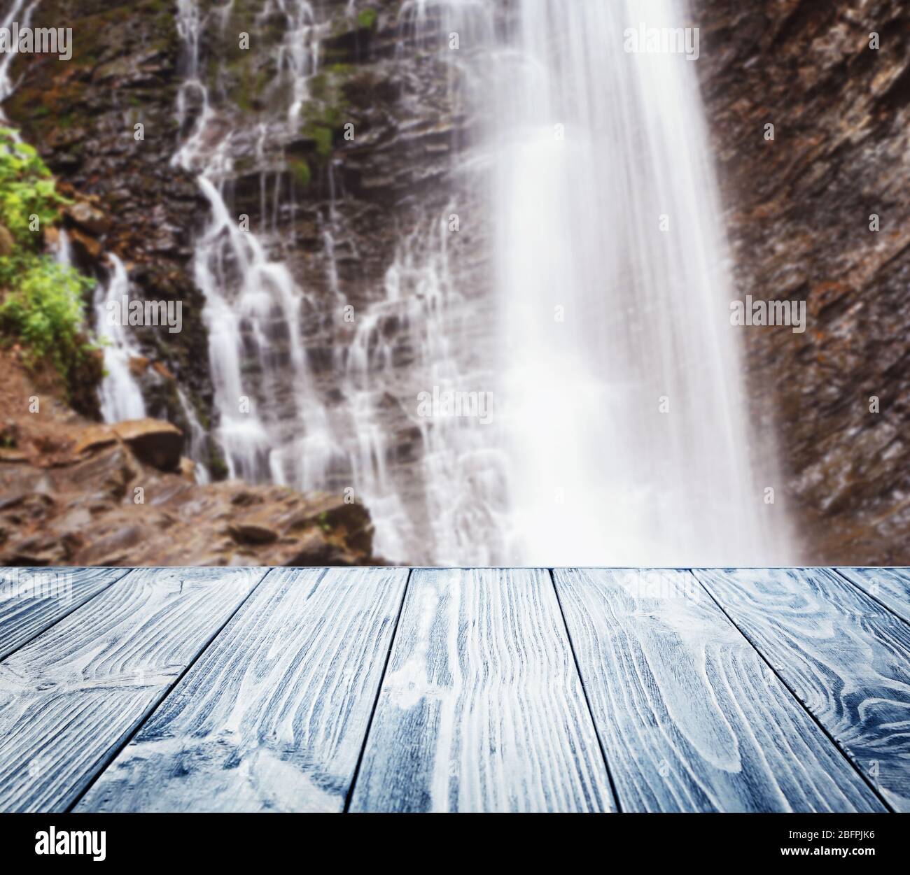 Wooden table and waterfall on background Stock Photo - Alamy